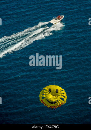 Aerial view, parasailing, parachute with a smiley, duo-parasailing ...