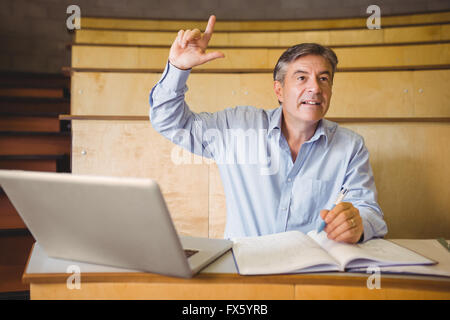 Confident professor raising his hand in classroom Stock Photo - Alamy