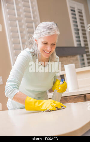 Woman cleaning kitchen countertop with cleaning spray and rag Stock ...