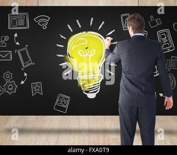 Composite image of businessman standing back to camera hands on head ...