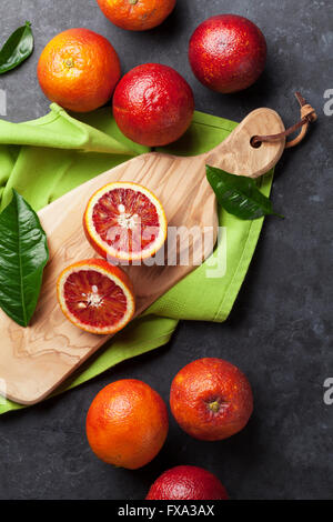 Fresh citruses on dark stone background. Oranges and limes. Top view ...