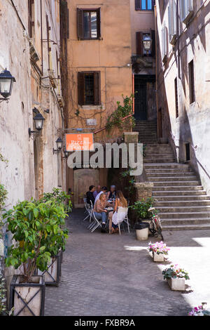 Italy. Rome. Diners enjoying eating outdoors at a small restaurant ...