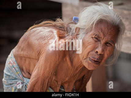 Burma, Myanmar, an old woman with white hair and tanned wrinkled skin ...