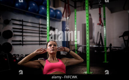 Woman doing abdominal crunches exercise on the fitness mat in summer ...