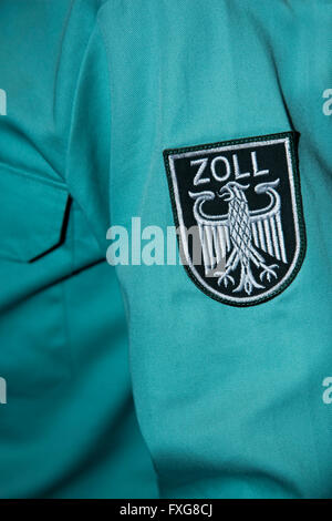 Customs officer with customs coat of arms Stock Photo - Alamy