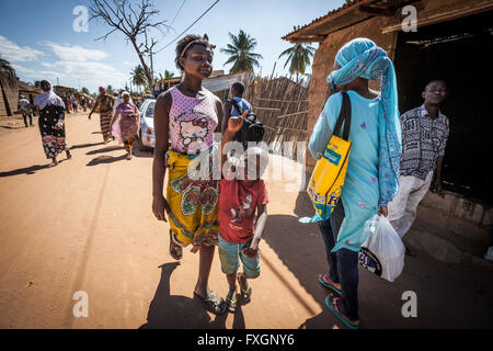 Mozambique, women walking in the street in traditional colored clothes ...