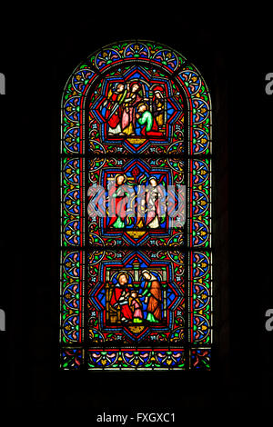 STAINED GLASS WINDOW OF ELY CATHEDRAL IN BACKGROUND WITH CARVED FIGURE ...
