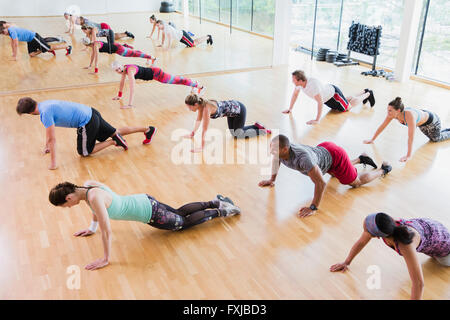 High-angle view of a fitness instructor motivating three young people ...