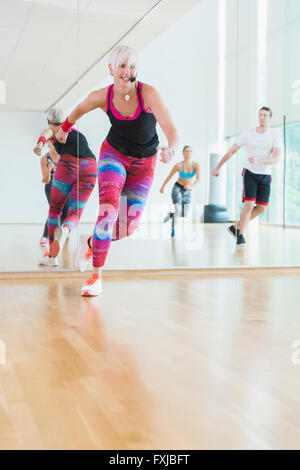 Full body of energetic young man doing acrobatic handstand while ...
