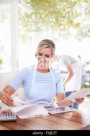 Smiling business woman holding clipboard Stock Photo - Alamy