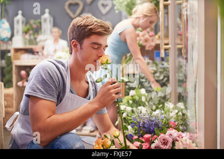 Young florist in a flower shop dealing with flowers Stock Photo - Alamy