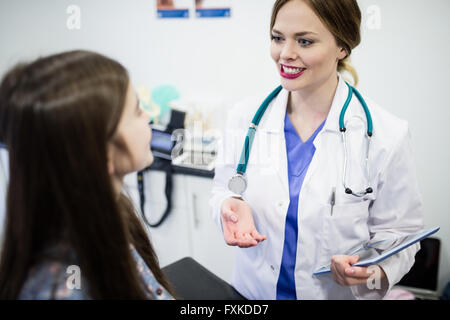 Doctor talking to a sick girl Stock Photo - Alamy