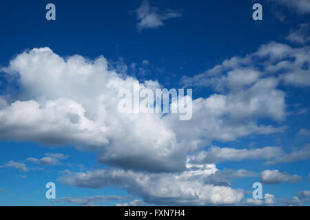 White fluffy cumulonimbus clouds forming before thunderstorm on summer ...