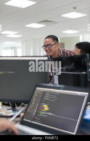 Asian Colleagues Software Developers Team Sitting At Desk Working Stock Photo - Alamy