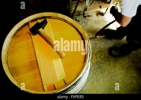 Person works with hammer on wooden to metal bracket among construction ...