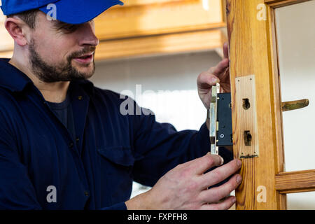 fixing the lock Stock Photo - Alamy