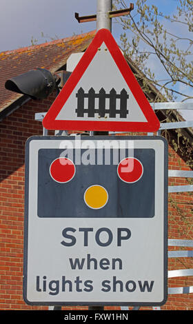 warning lights at an automatic half barrier railway level crossing with ...