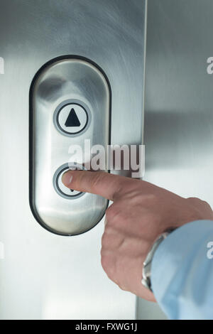 The man push lift button down Stock Photo - Alamy