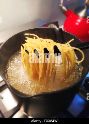 Cooking pot with boiling pasta on stove, closeup Stock Photo - Alamy