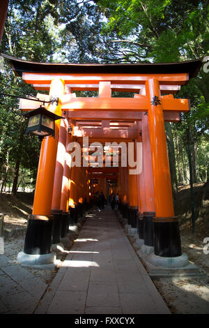 Front entrance of Fushimi Inari Shrine with large red torii gate and ...