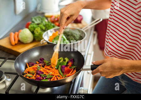 Midsection of woman cooking food Stock Photo - Alamy