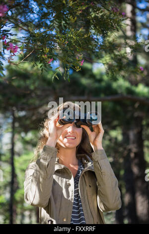Woman using binoculars Stock Photo - Alamy
