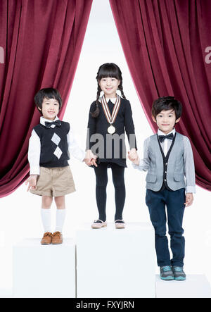 Child standing in front of three street musicians playing violin ...