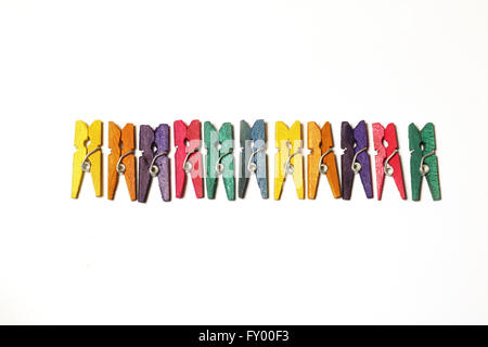 Mini colourful pegs on white background Stock Photo - Alamy