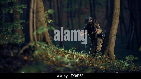 Soldier in Action at Night in the Forest Area. Night Time Military ...