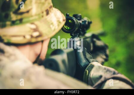 Hunter with Powerful Rifle with Scope Spotting Animals. Hunter with ...