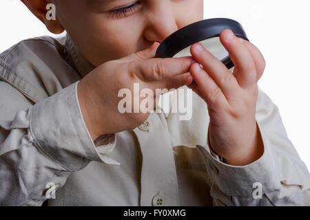 Baby holding a magnifying glass in hand on a white background Stock ...