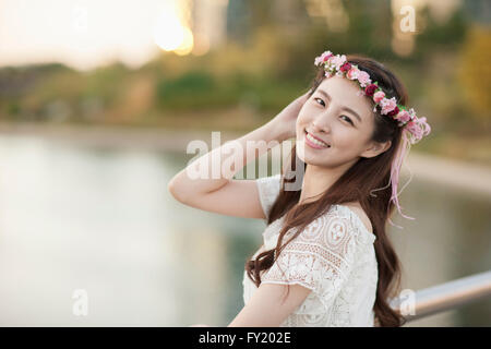 Smiling bride looking at camera near flowers outdoors, banner Stock ...