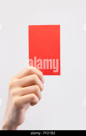 Referee showing a red card and gesturing to a football or soccer player ...