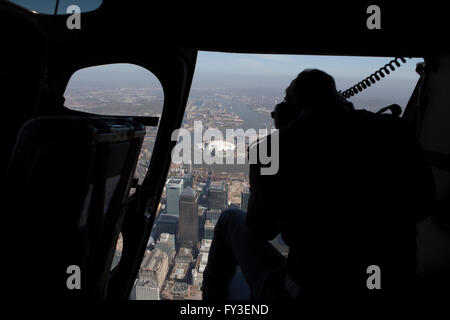 View from inside of Helicopter with door open over London during aerial ...