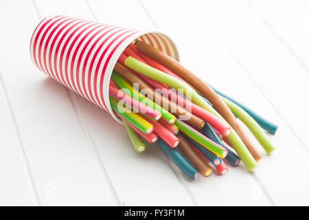 Cup with different tasty candies on color background Stock Photo - Alamy