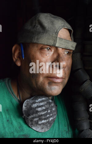 Hard working man face covered with oil Stock Photo - Alamy