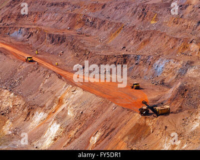Large, open-pit iron ore mine showing the various layers of soil and ...