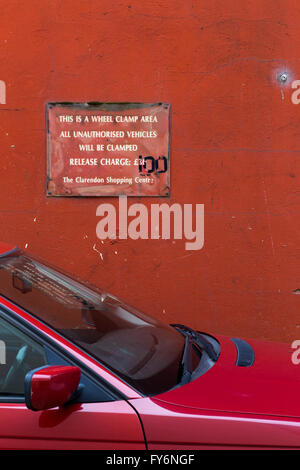 no unauthorised parking wheel clamp in operation release fee sign on a ...