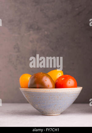 Still life with different color tomatoes Stock Photo - Alamy