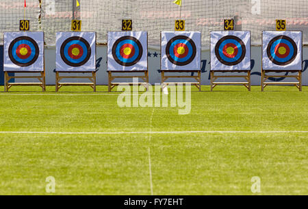 Six archery target rings during an archery competition. Green grass ...