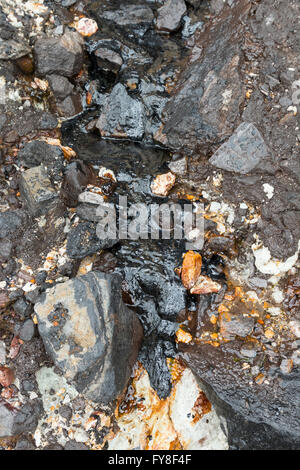 Bitumen seeping out of oil bearing rocks in an old quarry in Napo ...
