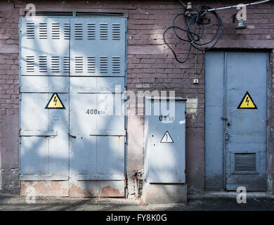 old rusty metal door to the substation with a lock and with a ...