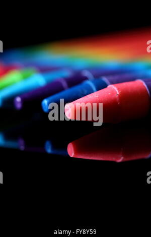 some colored wax crayons on a red surface Stock Photo - Alamy