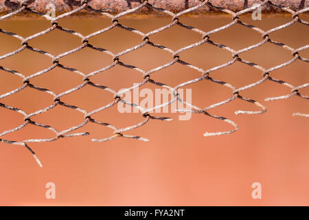 An old chain-link fence with broken wooden slats Stock Photo - Alamy