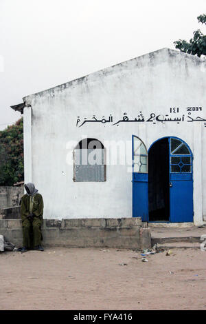 Everyday life at Tanji village, man outside an islamic temple with ...