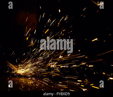 Sparks in the dark from a working grinding machine Stock Photo - Alamy