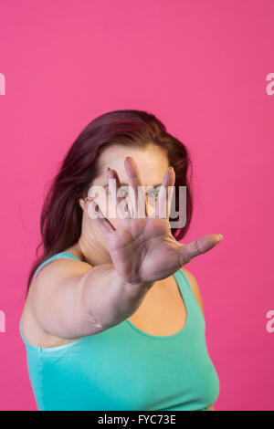 Woman showing a talk to the hand gesture Stock Photo - Alamy