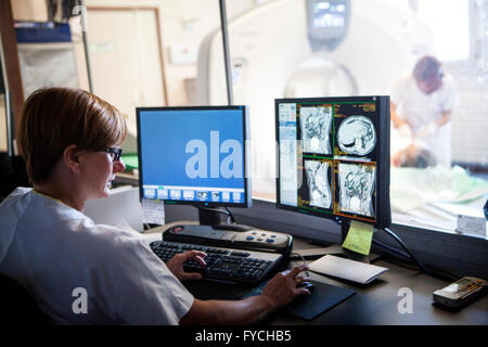 Old man having CT scan procedure sitting on CT machine scanner in ...
