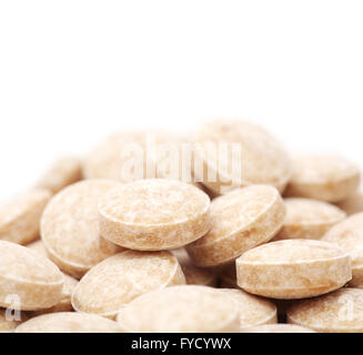 A pile of medical pills on a gray-pink background. Medications ...