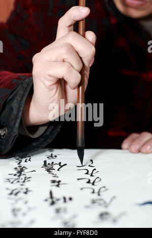 Pen writing Chinese characters Stock Photo - Alamy